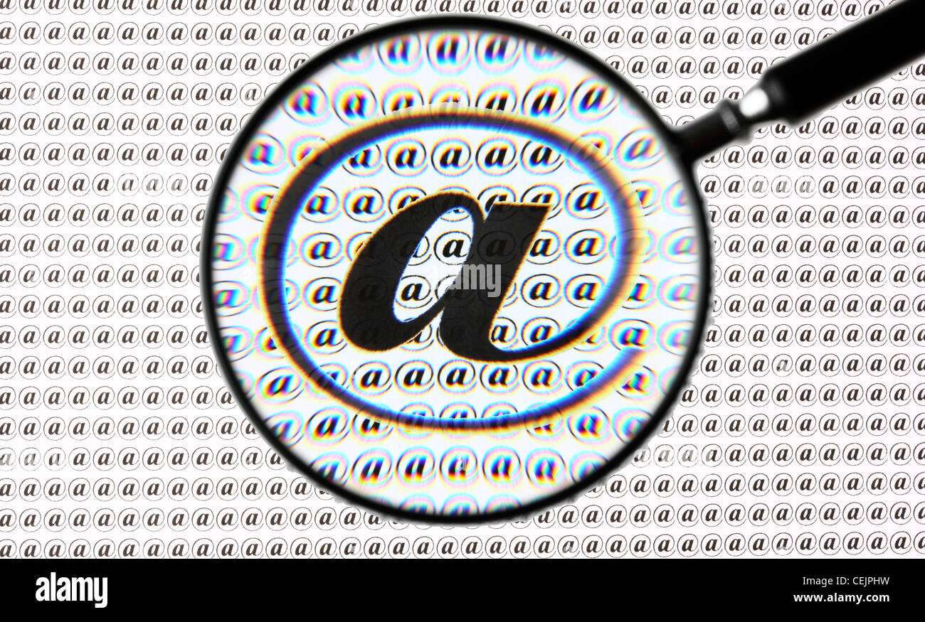 Magnifying glass highlighting a @ sign, Internet, E-mail symbol ...