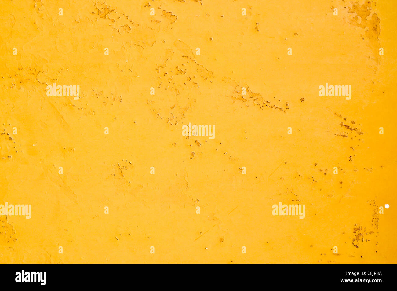 Yellow painted wall with spots of rust Stock Photo - Alamy