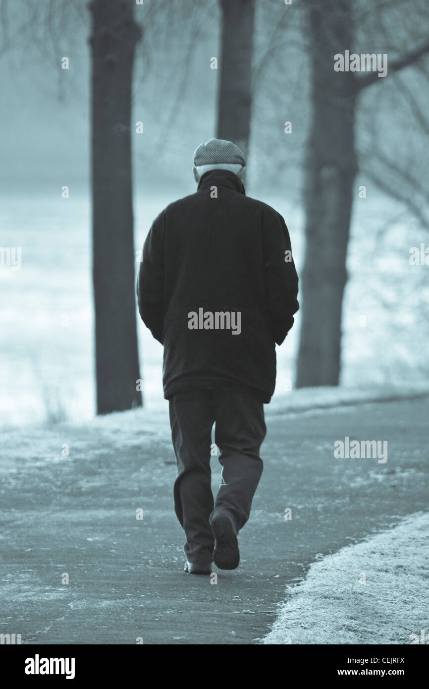 Man walking in park on winters day, England, UK Stock Photo - Alamy