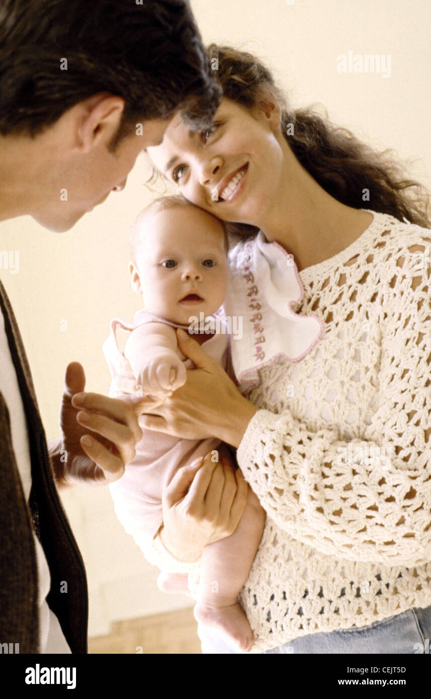 Brunette male and female with female child under year Stock Photo - Alamy
