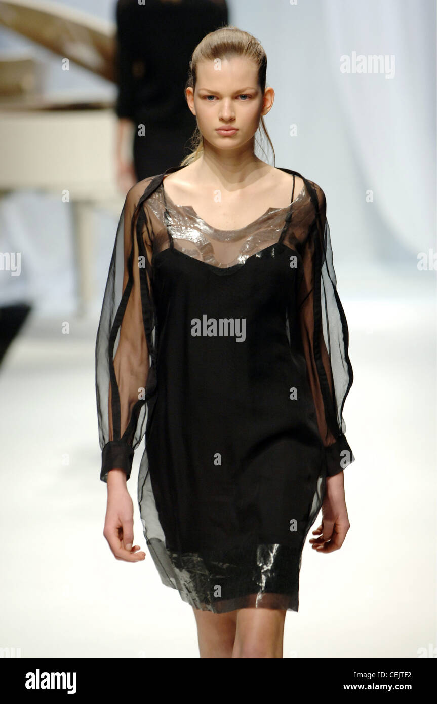 Hussein Chalayan Ready to Wear Paris A W Blonde female model wearing a knee length sheer chiffon ...