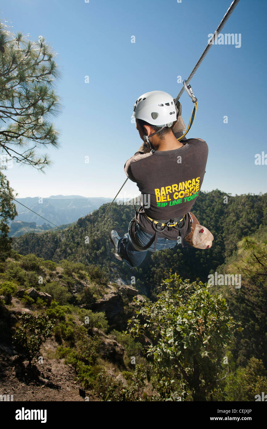 A man executing a zip line in the Copper Canyon, Chihuahua, Mexico ...