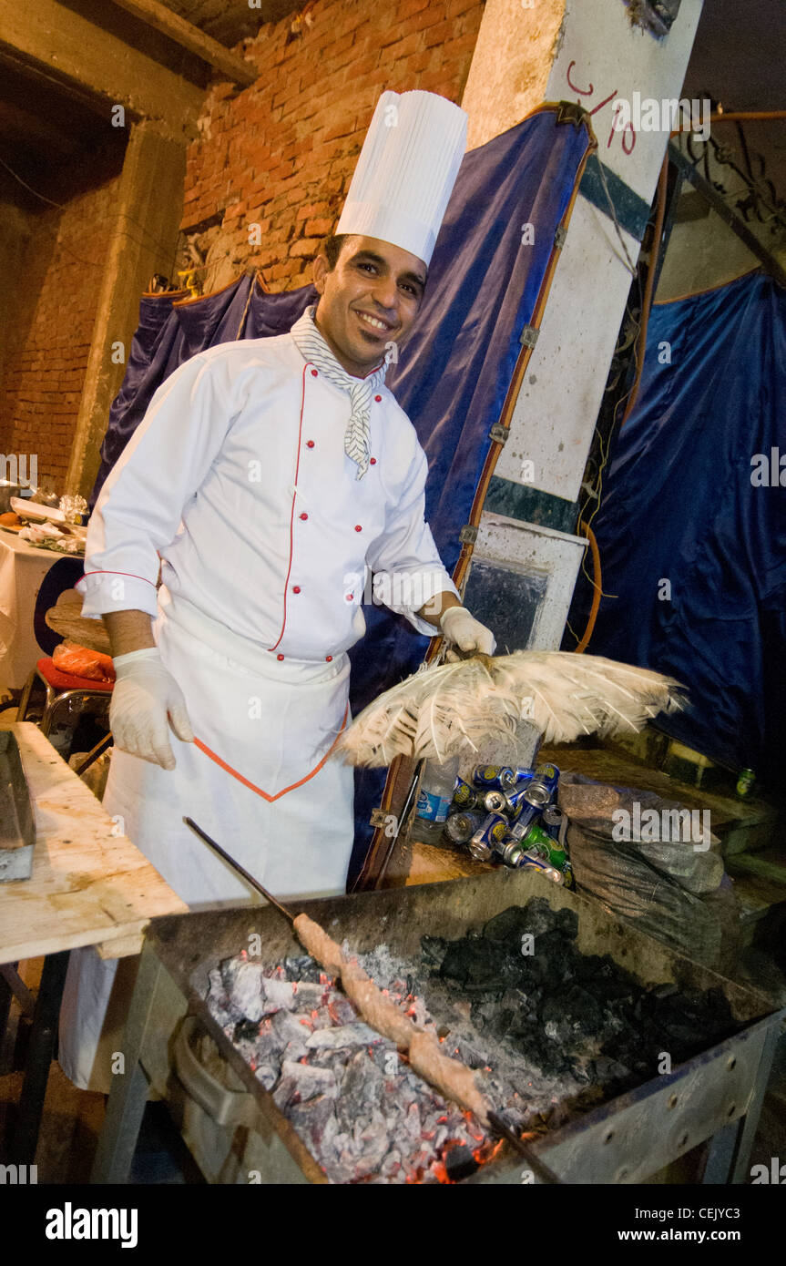 Cook making bbq for guests at party in Cairo Egypt Stock Photo - Alamy
