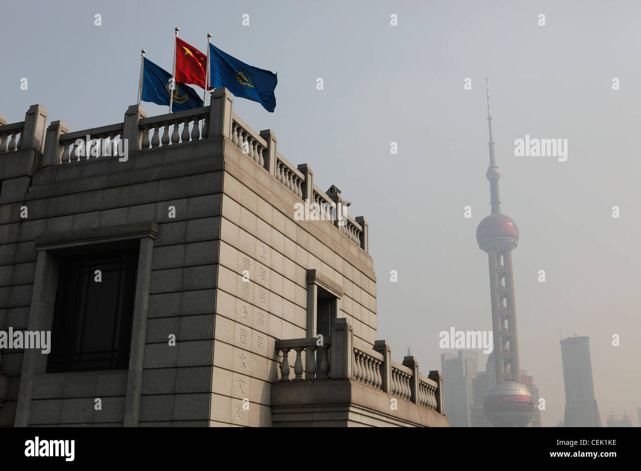 Chinese flag on building with Pearl Tower in background Stock Photo - Alamy