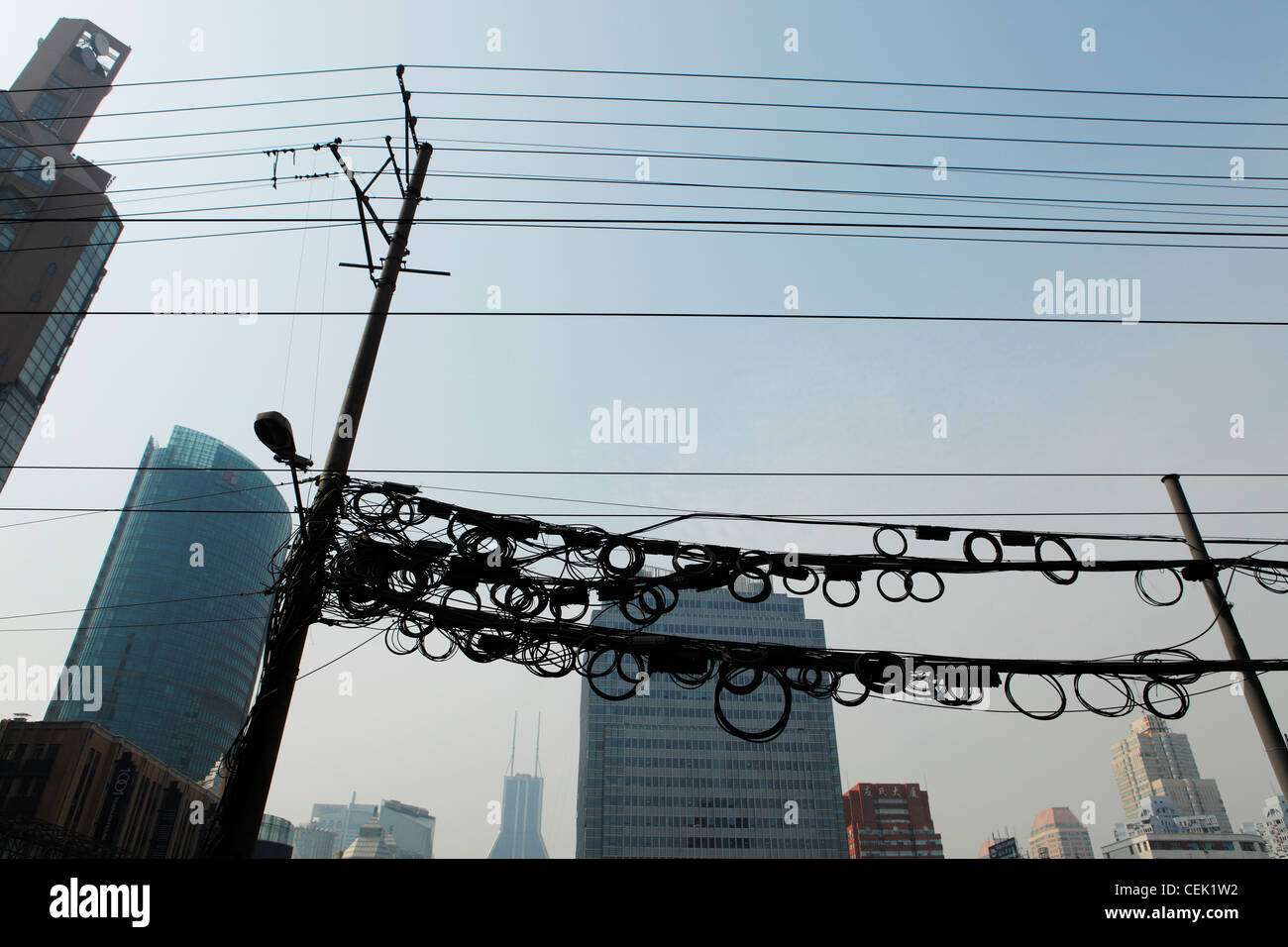 Coiled electrical wires above the street. Shanghai, China Stock Photo ...