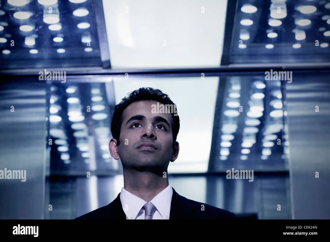 Young man in business suit standing in elevator Stock Photo - Alamy