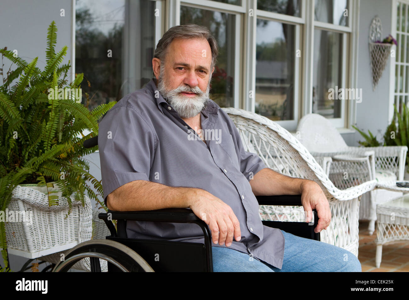 Disabled paraplegic man sits depressed in his wheelchair posing on the ...