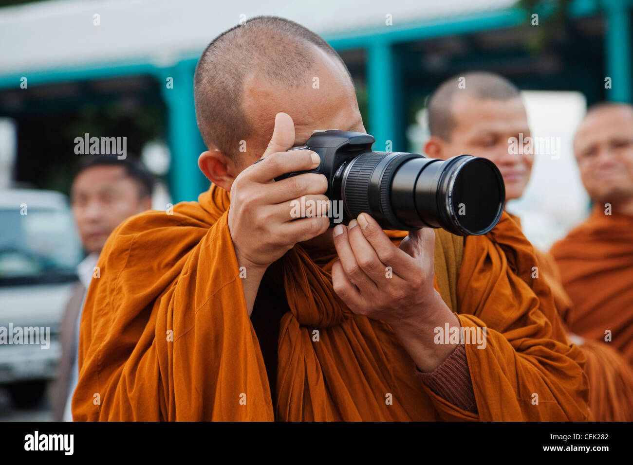 Monk taking photos with camera, Bangkok, Thailand Stock Photo - Alamy