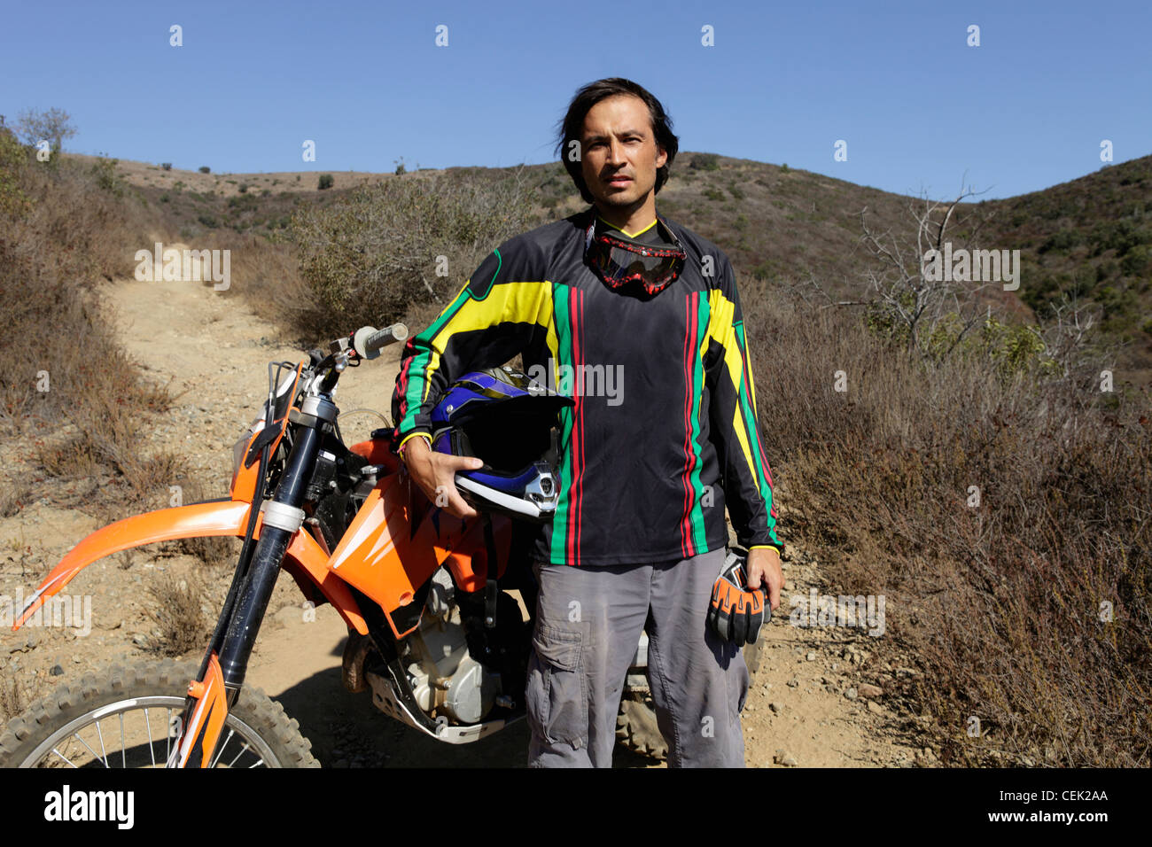 Man stands in front of off road motorcycle Stock Photo - Alamy