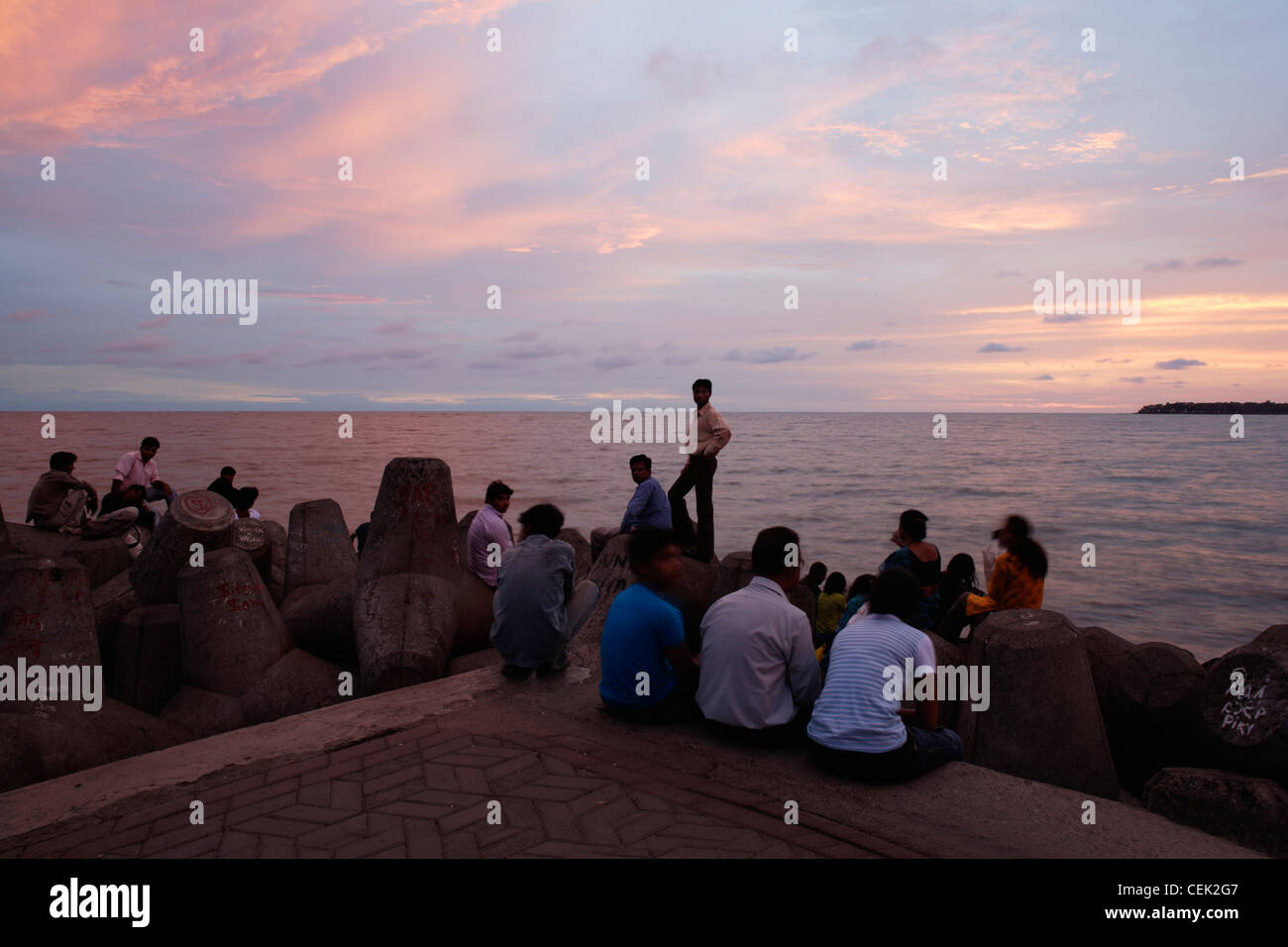 Small crowd gathered at the sea shore at sunset, Mumbai, India Stock ...