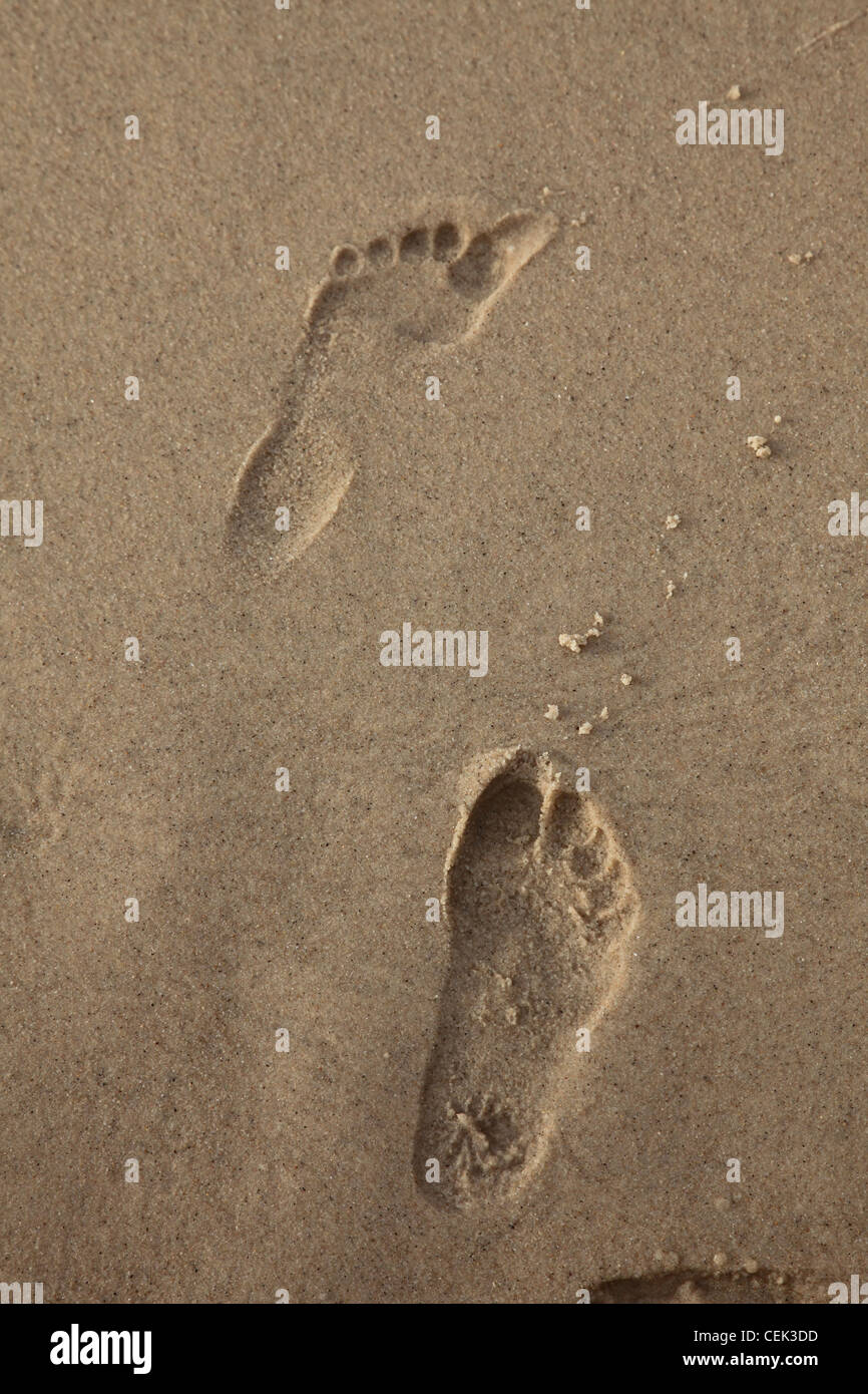 Human trace of a foot on yellow sand Stock Photo - Alamy