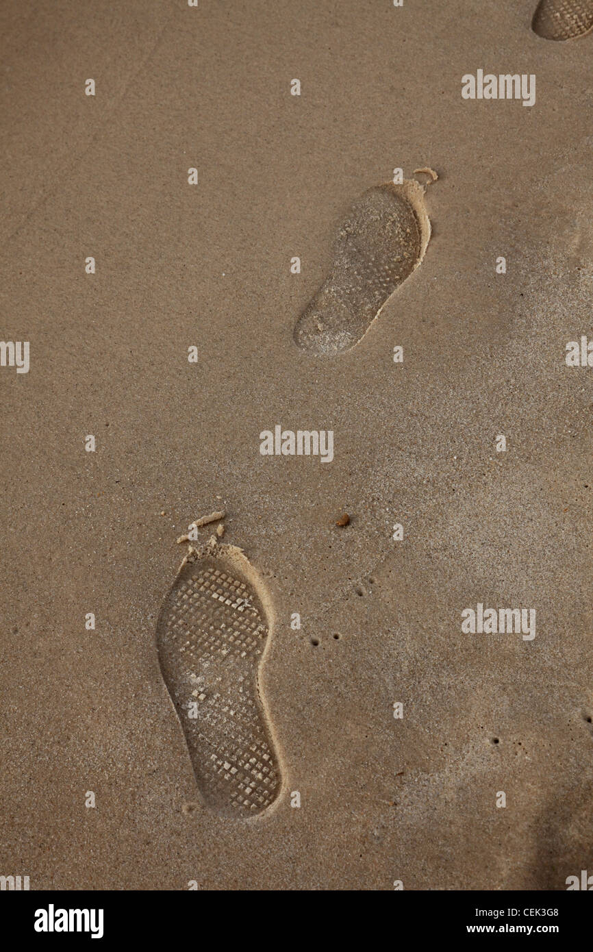 Human trace of a foot on yellow sand Stock Photo - Alamy