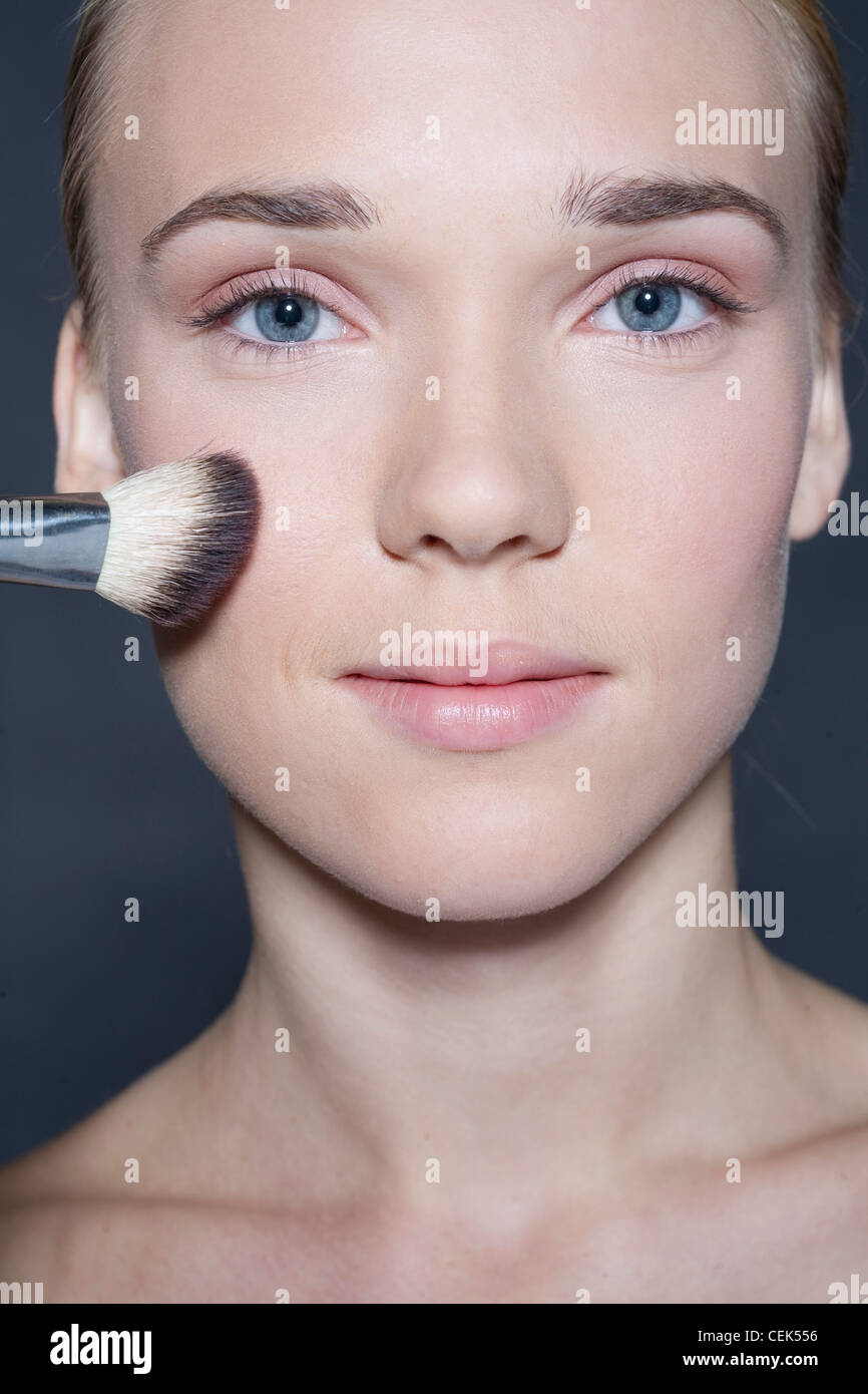 Step by Step Beauty and Make Up Female applying blusher to her cheek ...