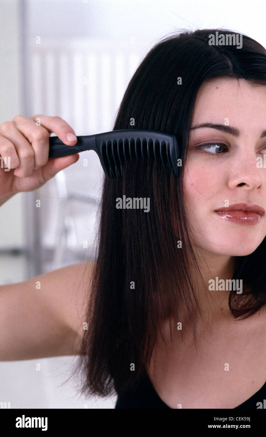 Step by Step Hair Updo Female with brunette hair, combing hair with ...