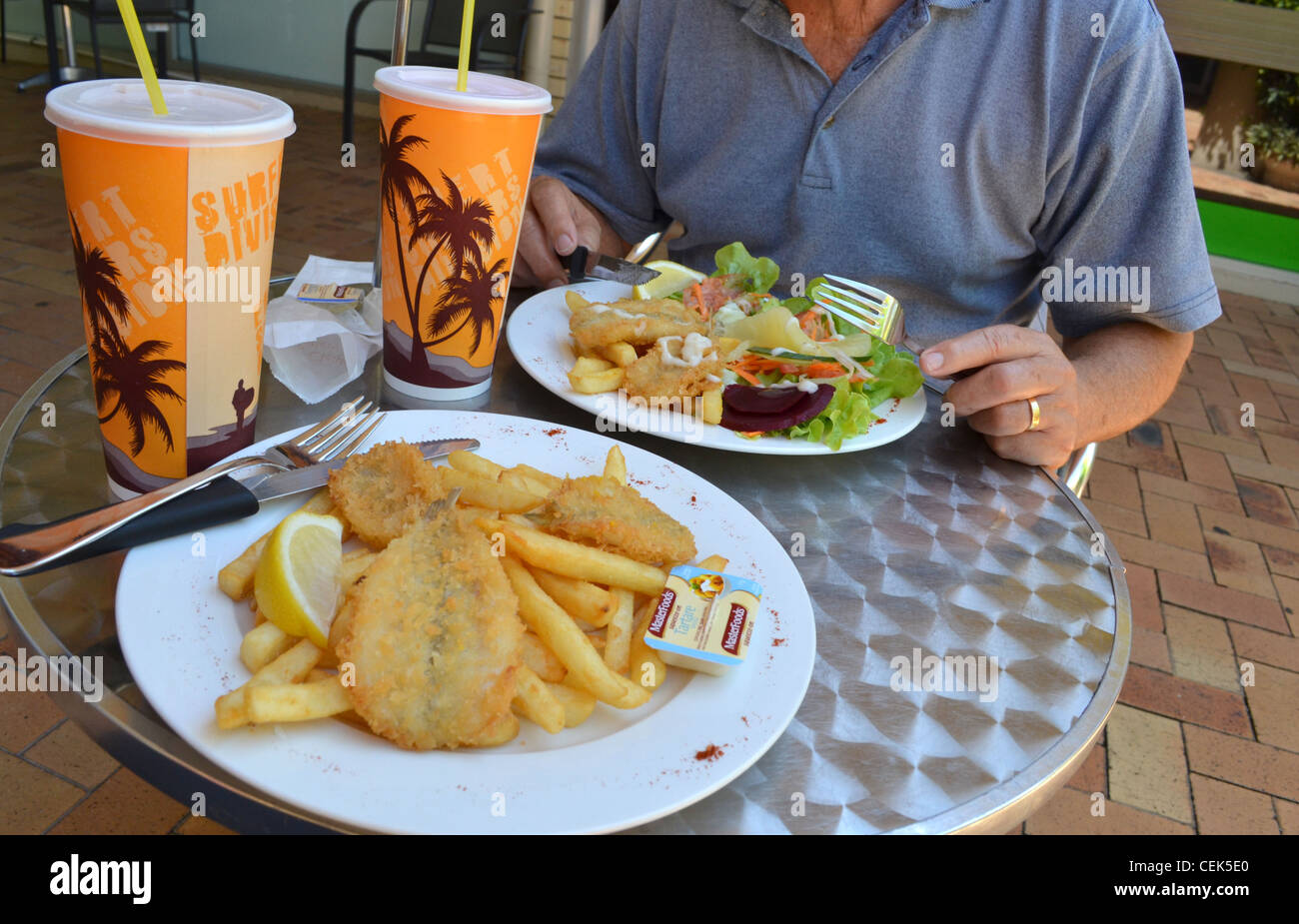 Fish and chips with milkshake at an outdoor restaurant Stock Photo - Alamy
