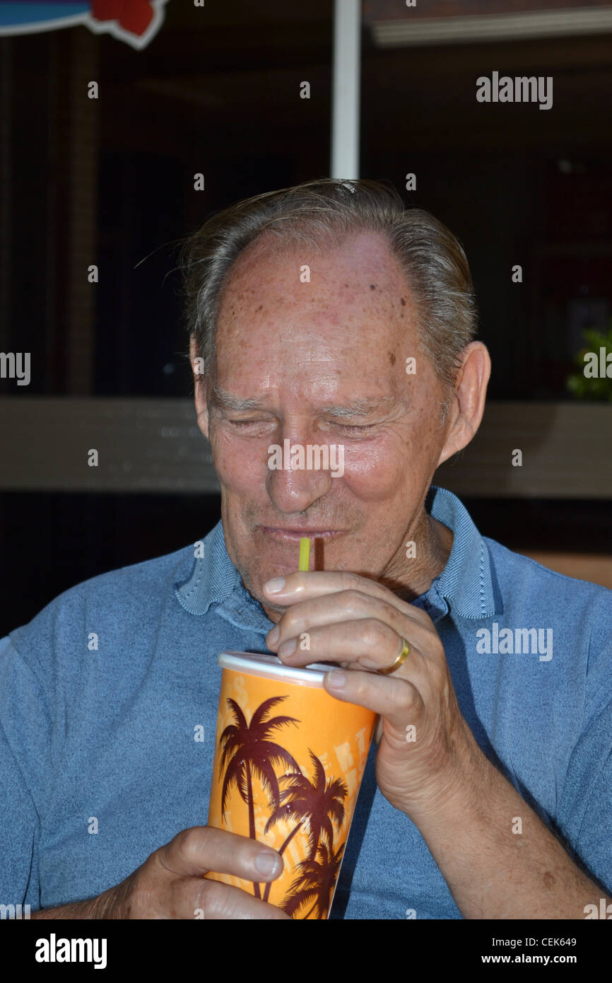 old retired man drinking a milkshake Stock Photo - Alamy