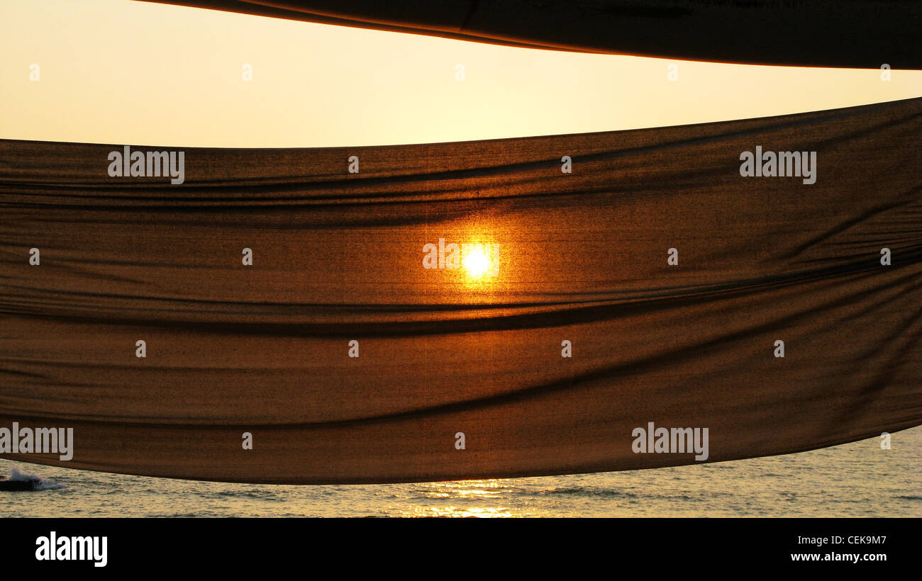 Sunset through a canopy on Patnem Beach, Goa (by Palolem beach), India ...