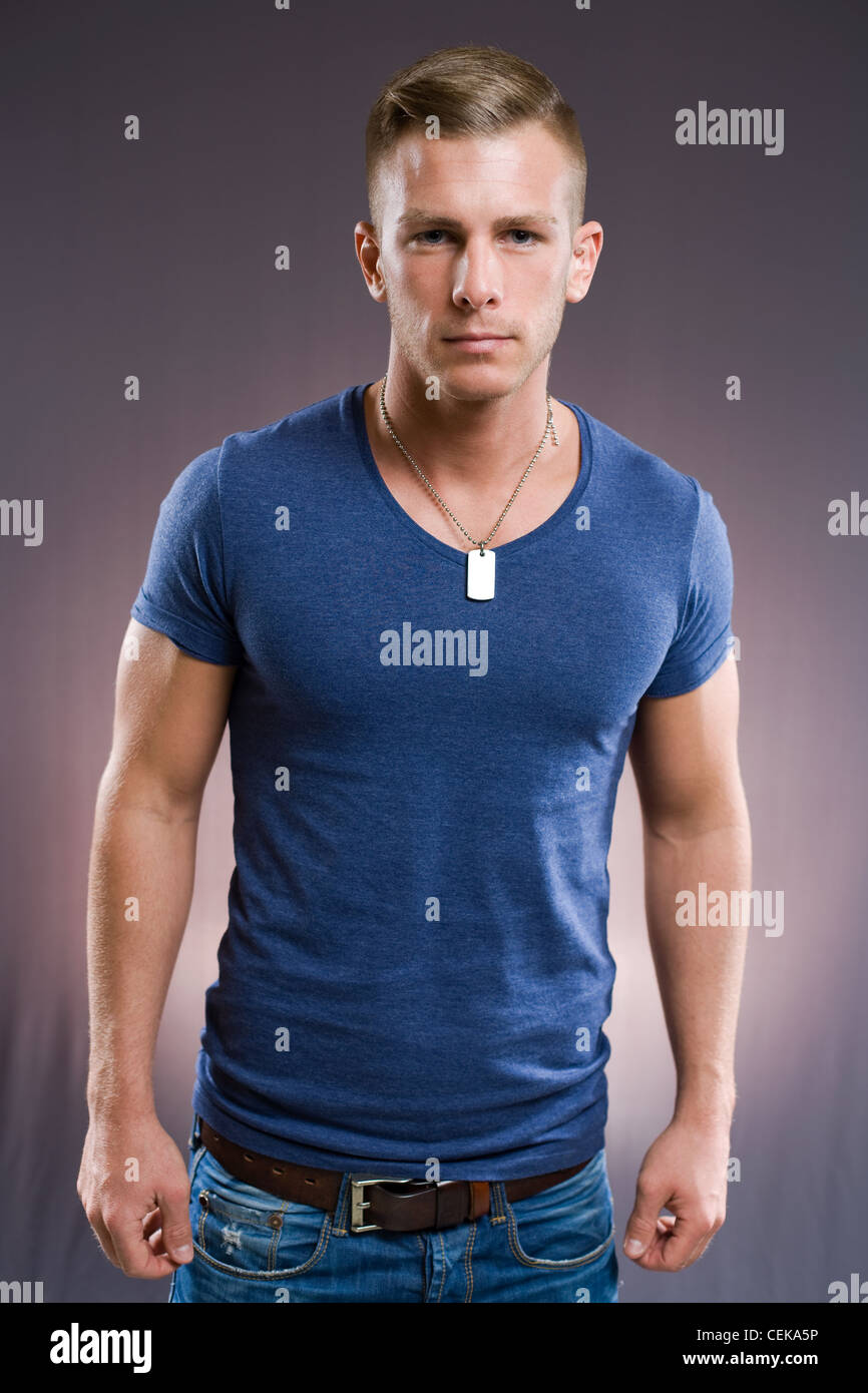 Portrait of masculine tough looking young man with serious expression ...