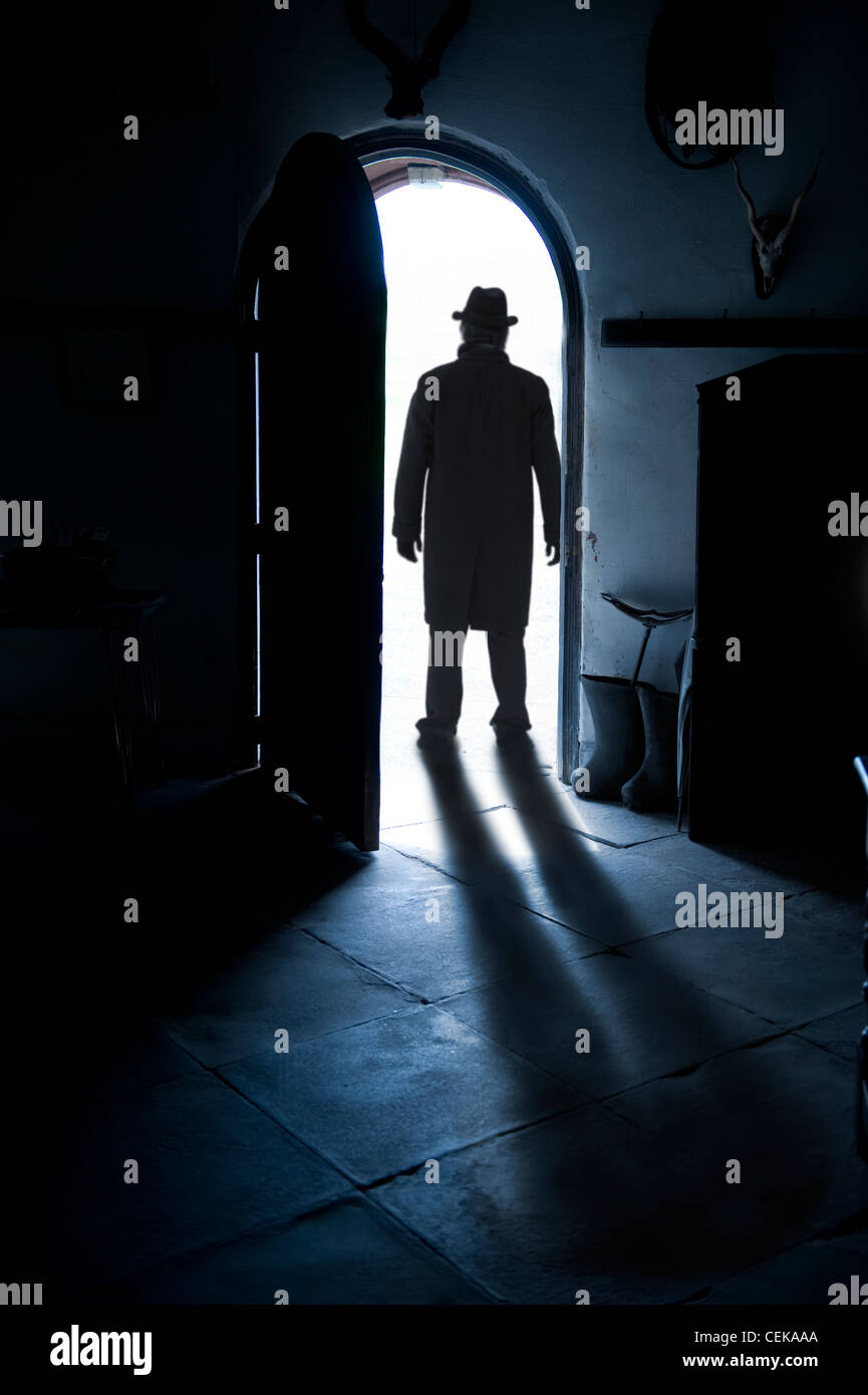 a man standing menacingly in an arched doorway in silhouette Stock ...