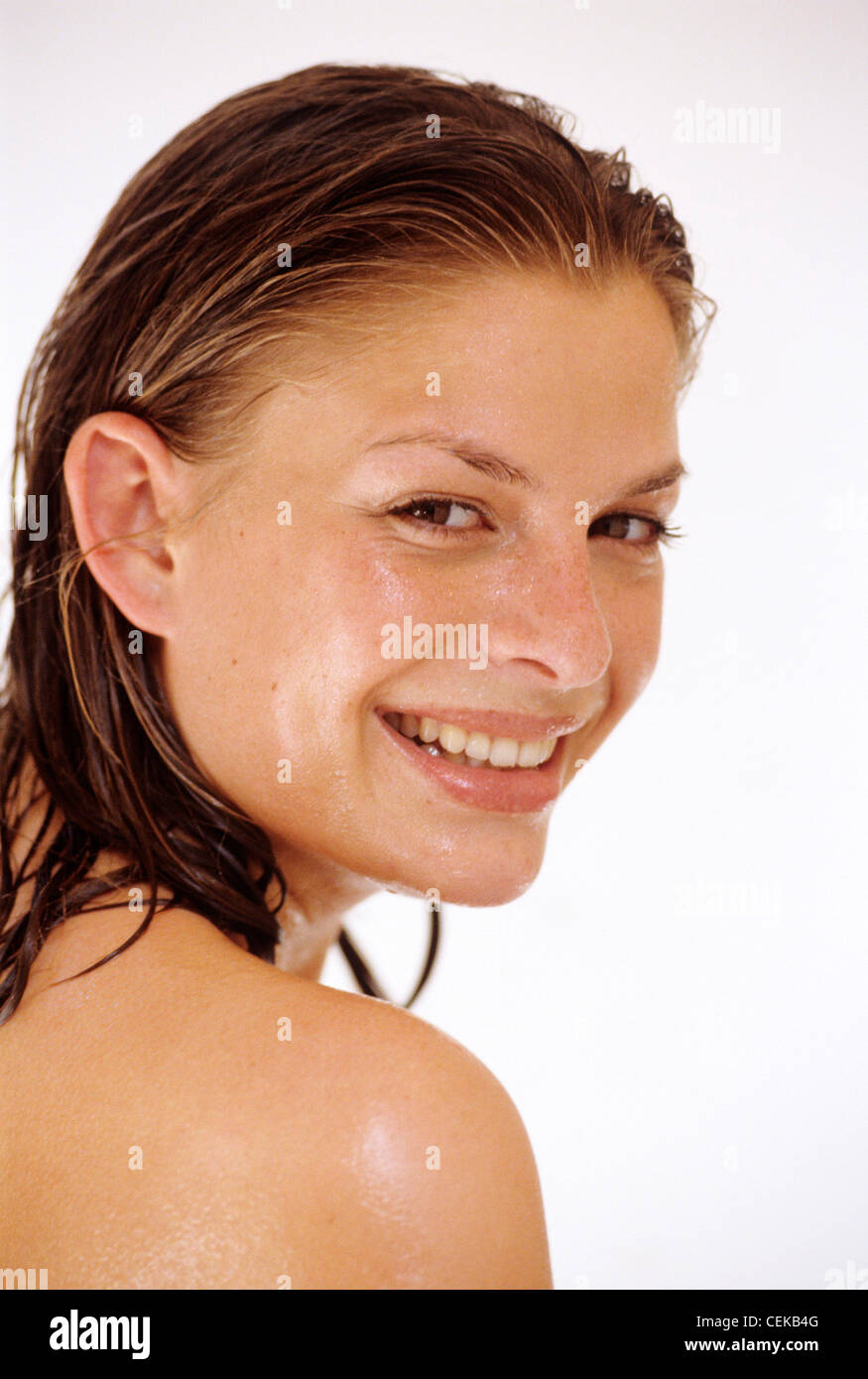 Female long wet brunette hair, droplets of water on face, looking back ...
