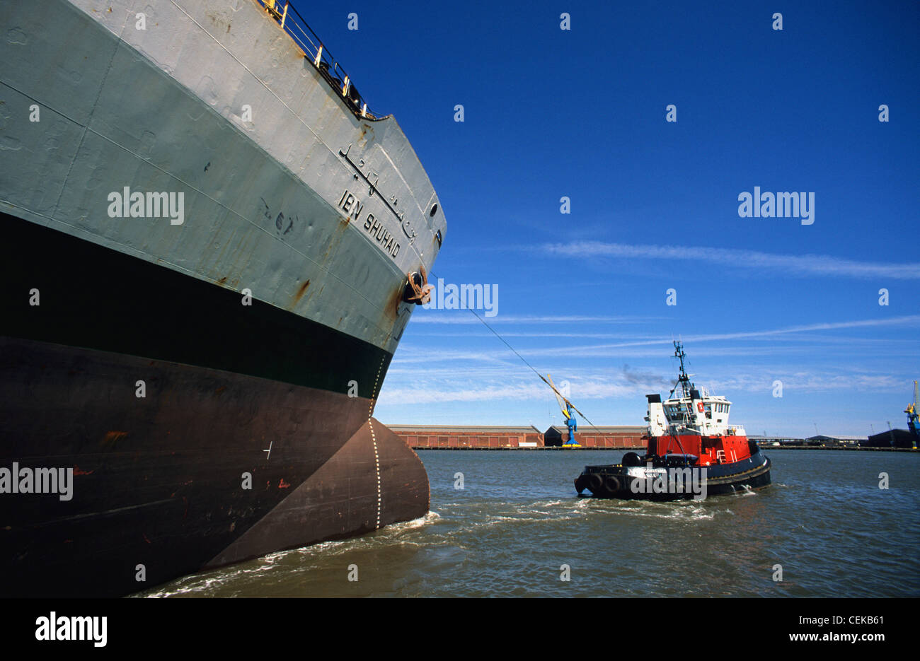 tug boat towing freighter into lock at the port of hull docks hull uk ...
