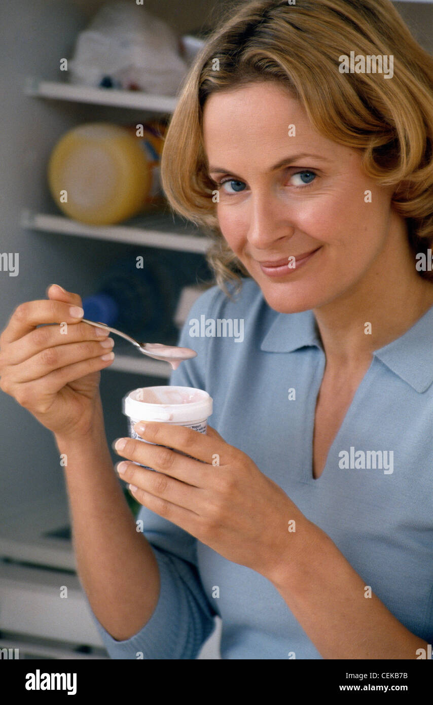 Female short fair hair, wearing a blue v neck top, sitting by the open ...