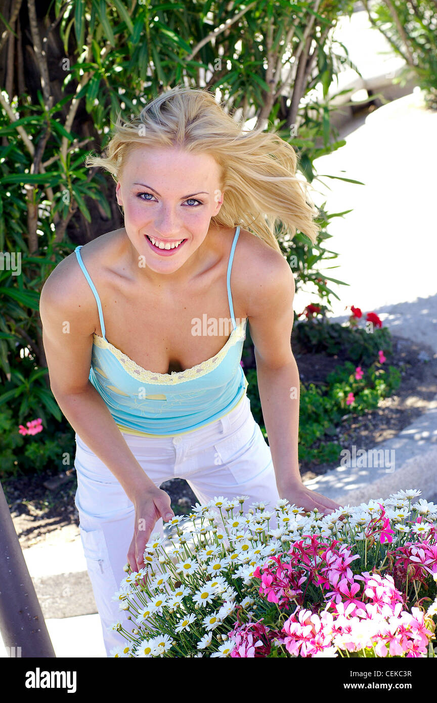 Female Shoulder Length Straight Blonde Hair Wearing Pale Blue Vest Top