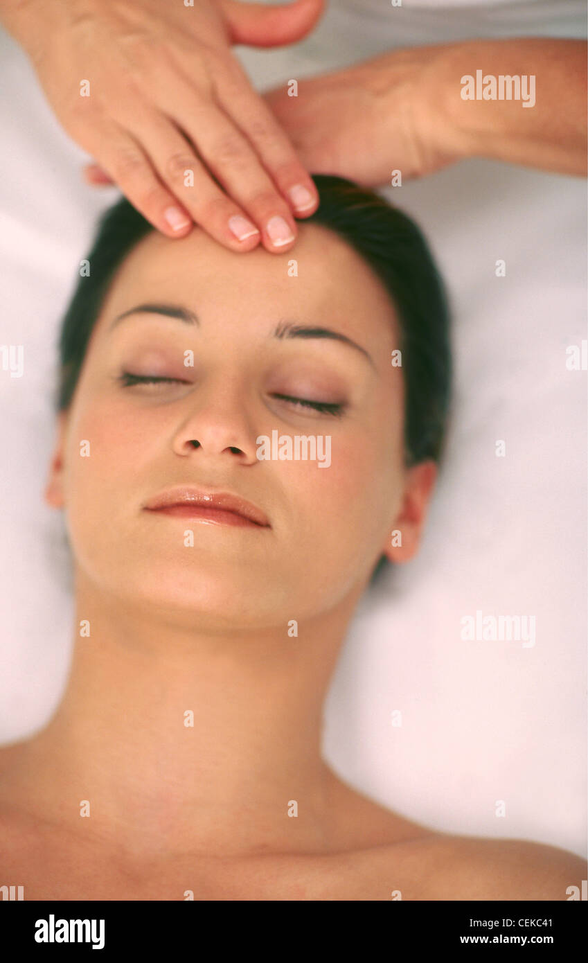 Female with brunette hair off face lying on back eyes closed, female ...