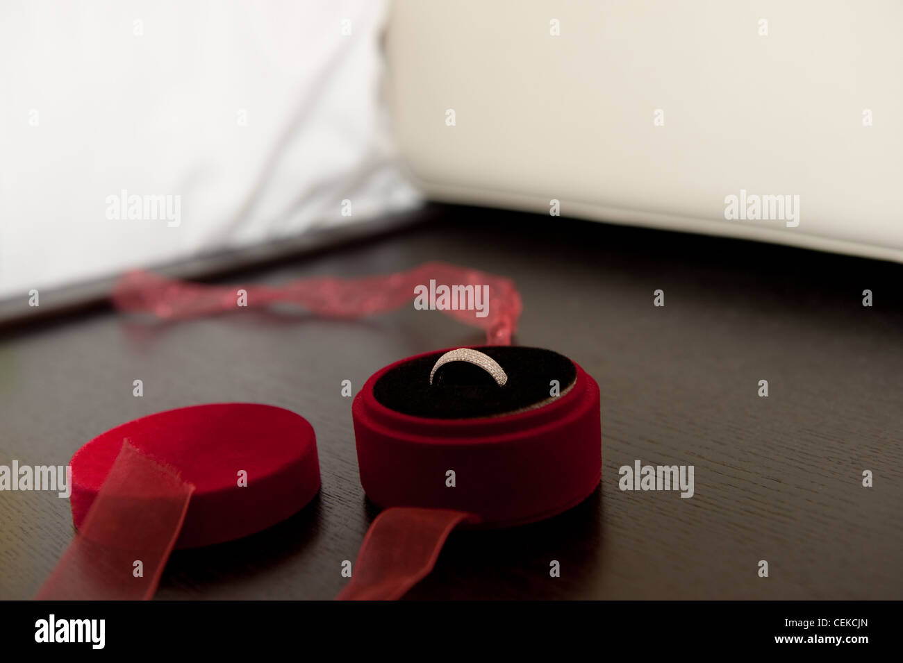 Opened red gift box with wedding ring Stock Photo - Alamy