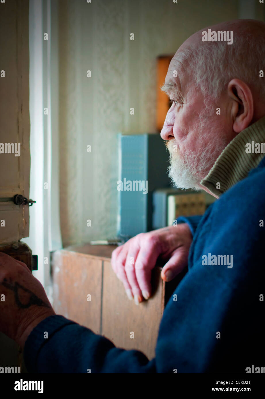 A scared old man opening door to stranger Stock Photo - Alamy
