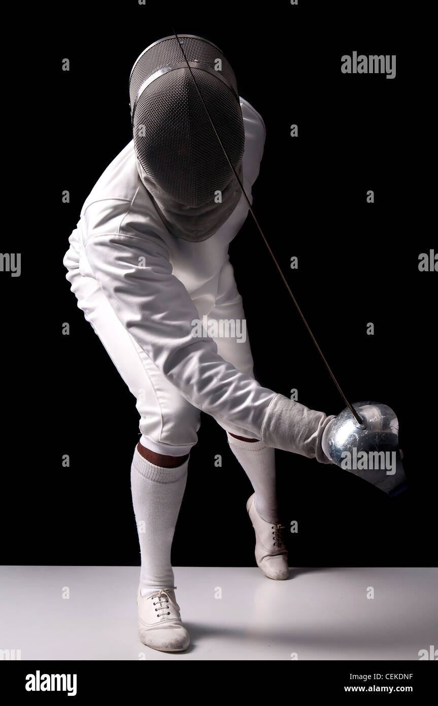 Male fencer isolated in a dark background Stock Photo - Alamy
