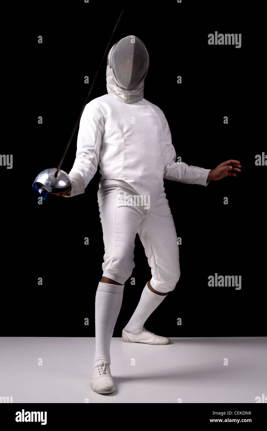 Male fencer isolated in a dark background Stock Photo - Alamy