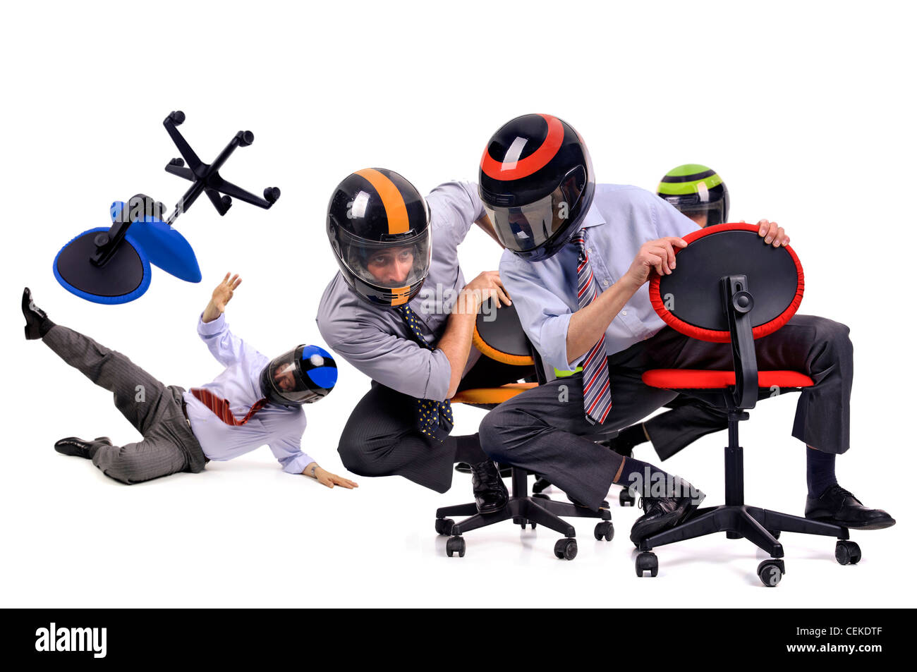 Businessmen racing in chairs with helmets Stock Photo - Alamy
