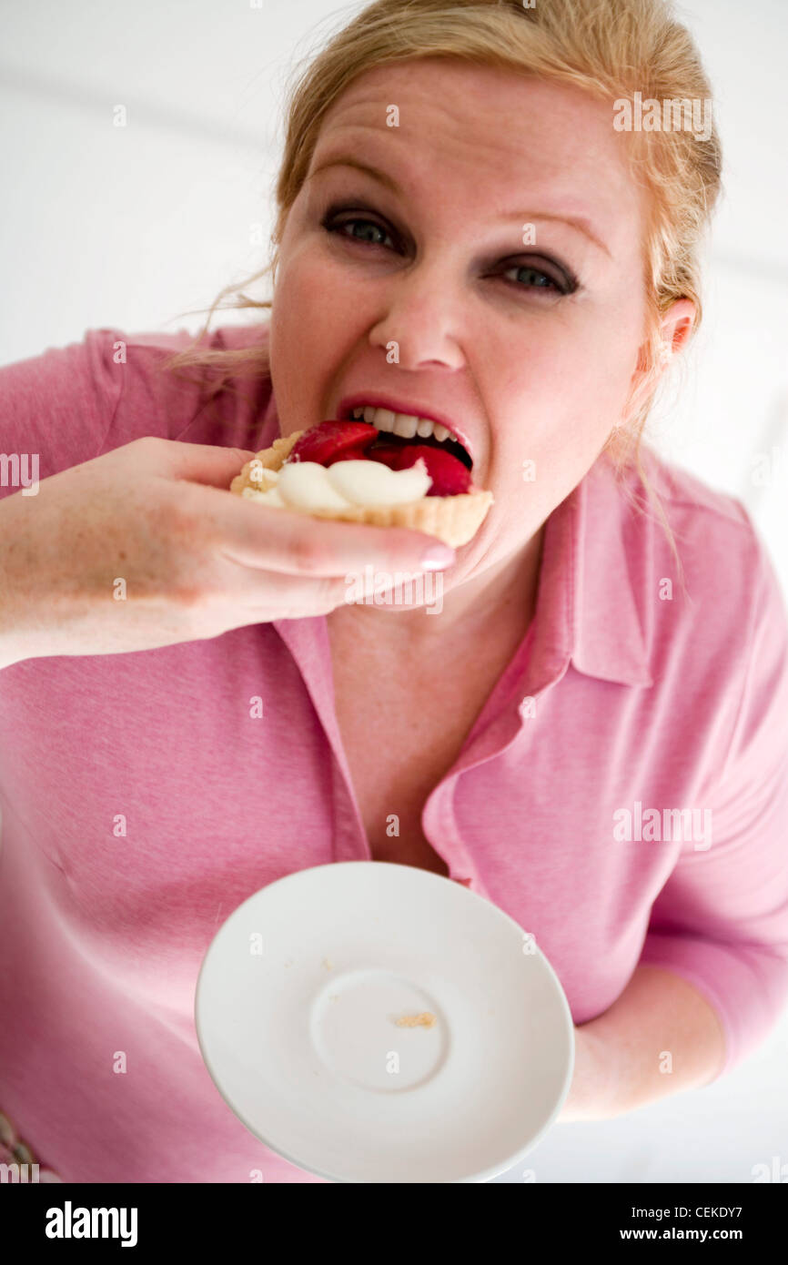 Woman eating cake guilty hi-res stock photography and images - Alamy