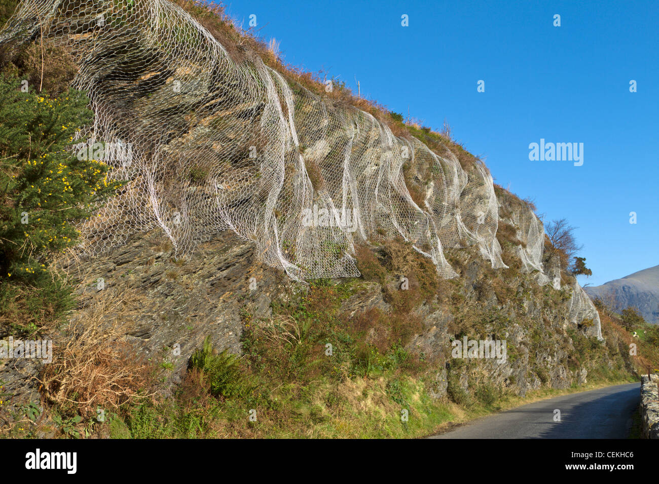 Netting to prevent rocks falling onto road Stock Photo - Alamy