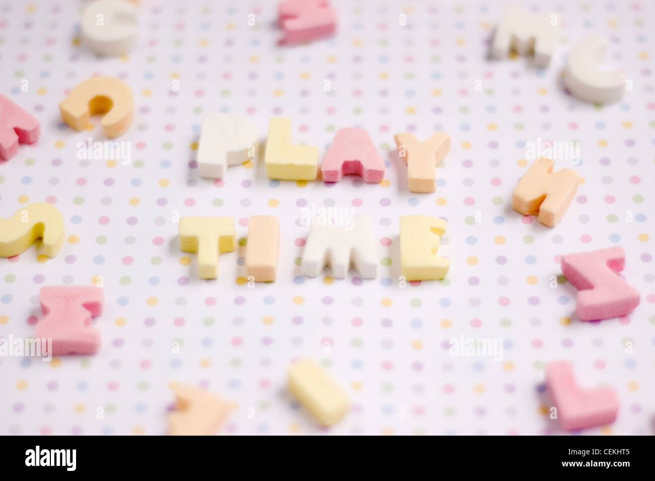 Sugar letter shaped sweets spelling the words play time Stock Photo - Alamy