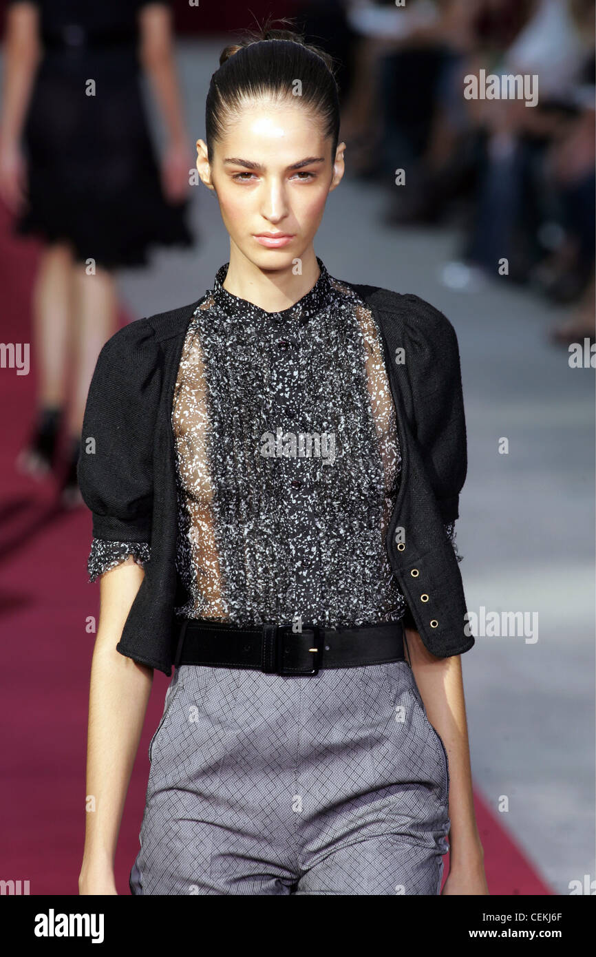 Female model dark brown hair pulled back wearing a short sleeved silver ...