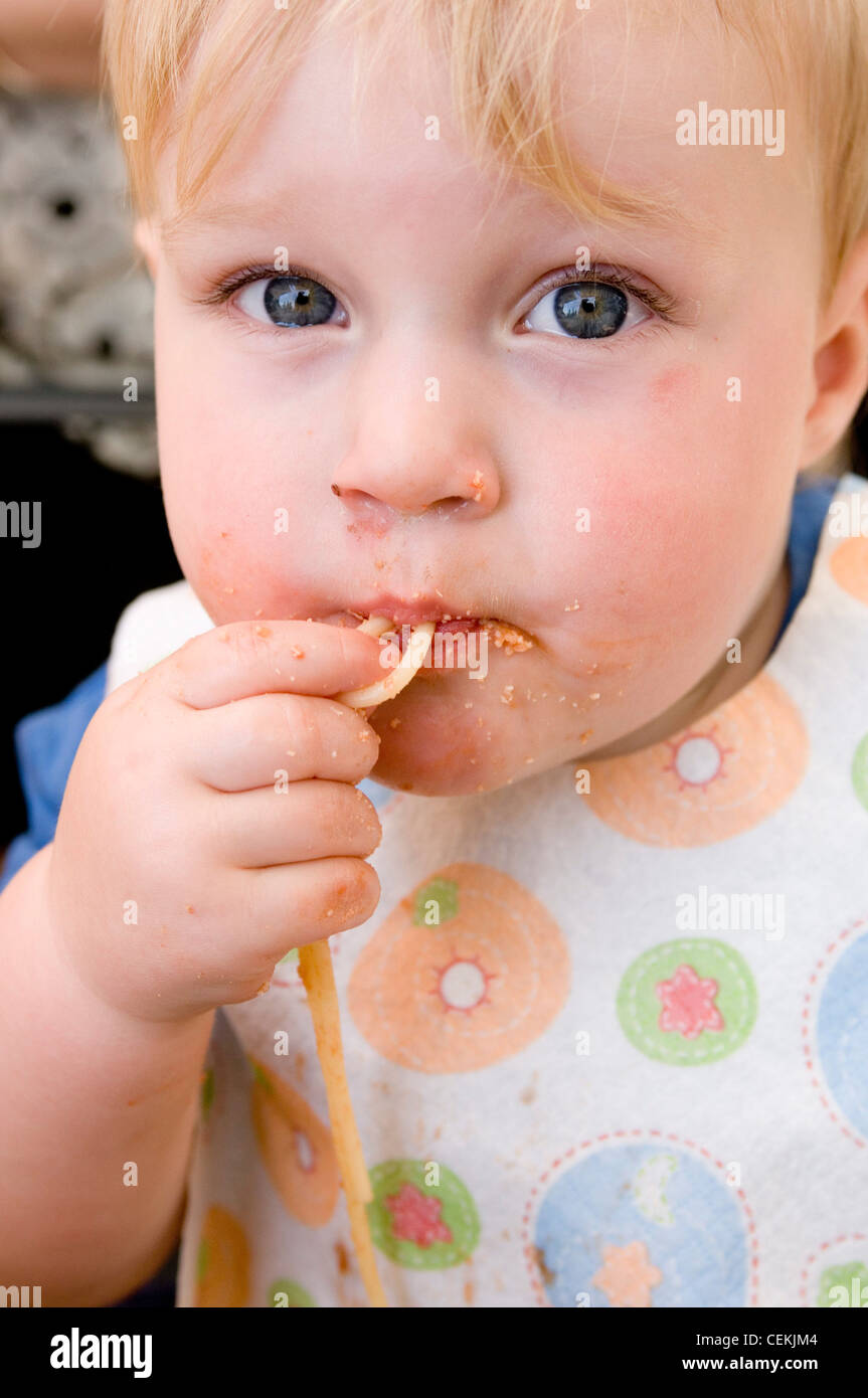 Male child eating spaghetti Stock Photo - Alamy