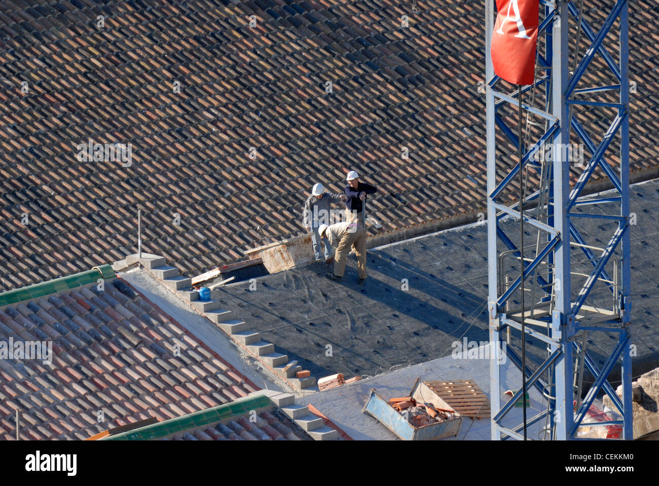 Barcelona, Spain. Men mending roof, seen from the top of the Monument a ...