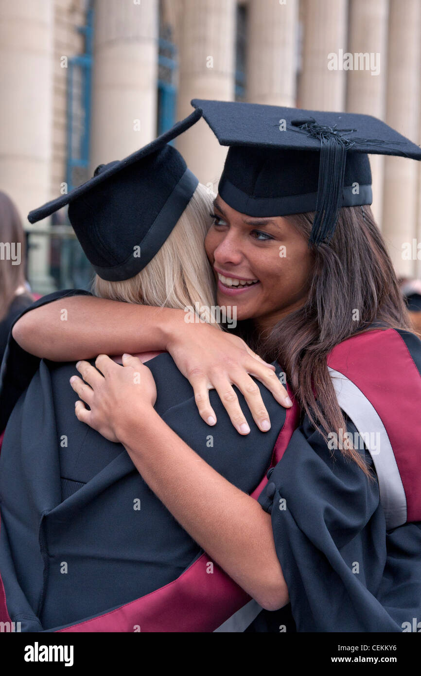 two female university graduates hugging Stock Photo - Alamy