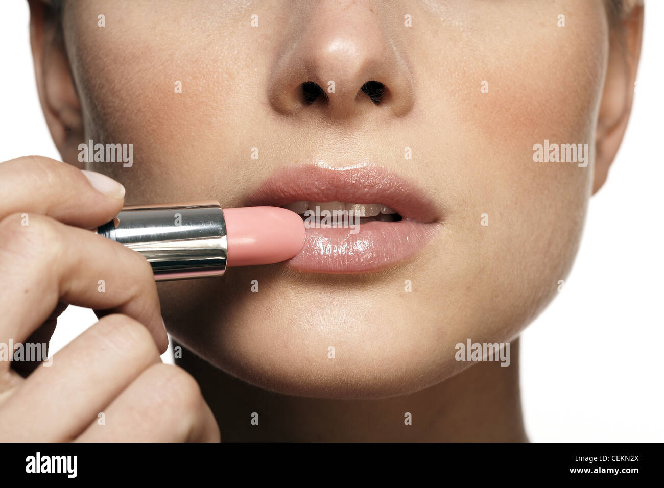 Female applying pink lipstick Stock Photo - Alamy