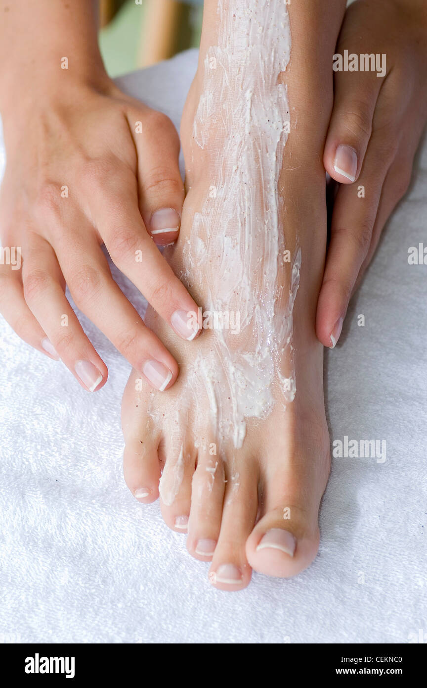 Female massaging foot scrub onto foot with fingers Stock Photo - Alamy