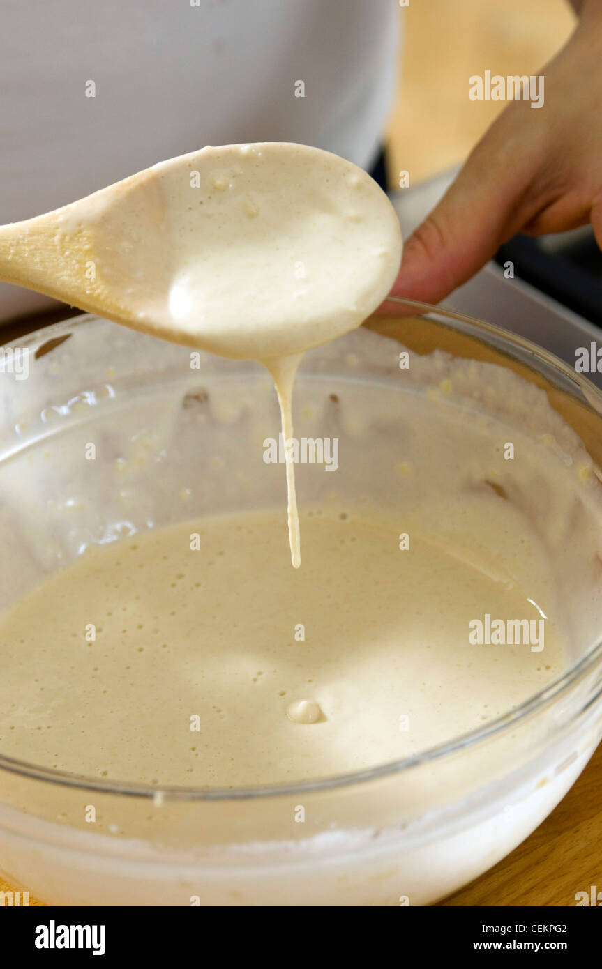 Step by step pancakes Smooth mixture in glass bowl with wooden spoon ...