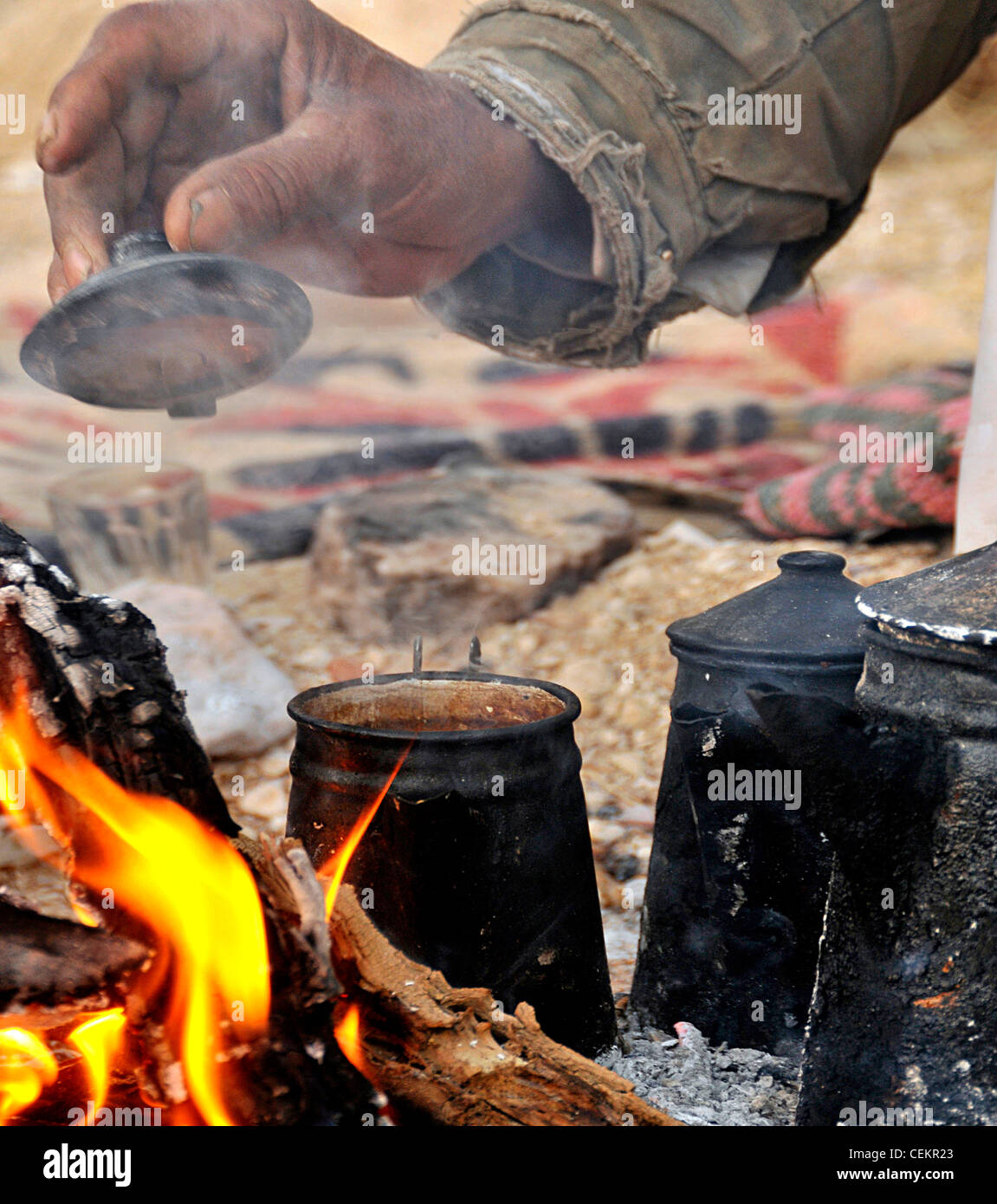 A typical middle east scene of an Arab preparing campfire tea in the ...