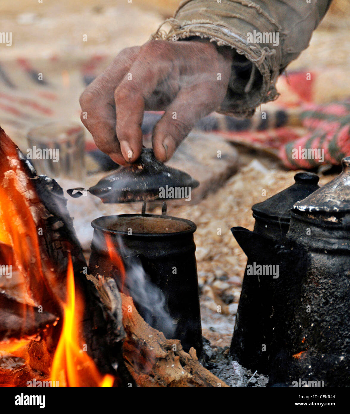 A typical middle east scene of an Arab preparing campfire tea in the ...