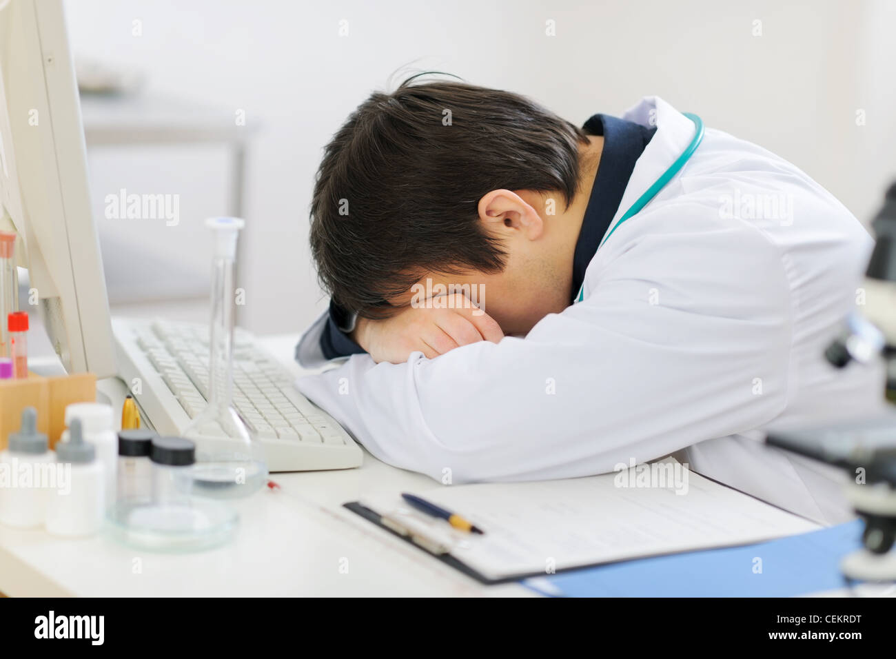 Tired medical doctor sleeping on keyboard Stock Photo - Alamy