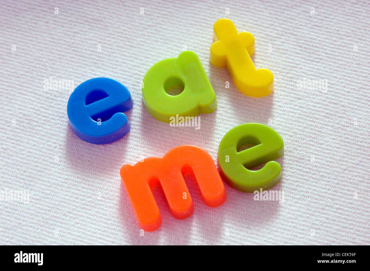 Plastic letters spelling the words eat me, on a white background Stock ...
