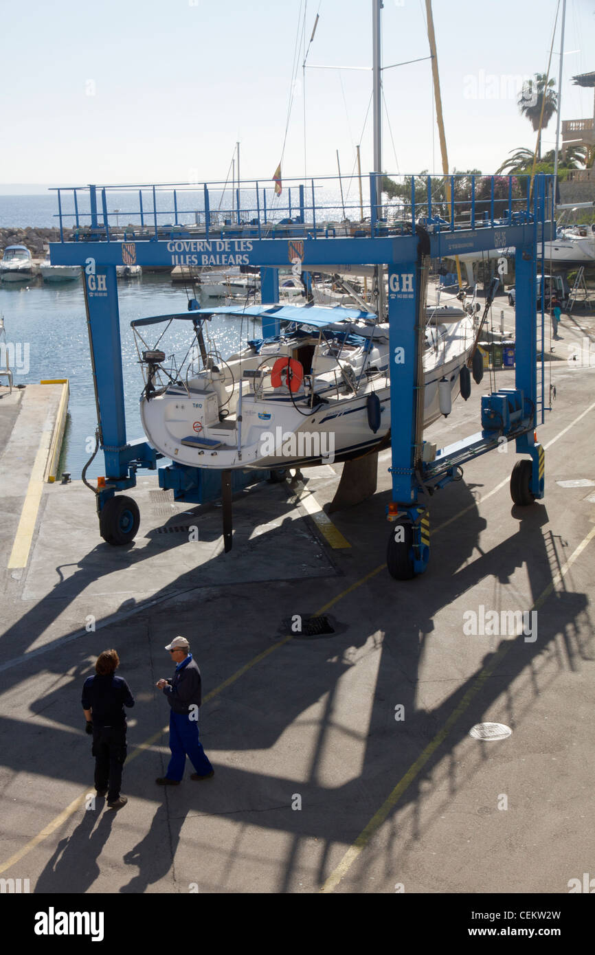 Men workers boats yard maintenance area on Cala Nova port yacht club ...