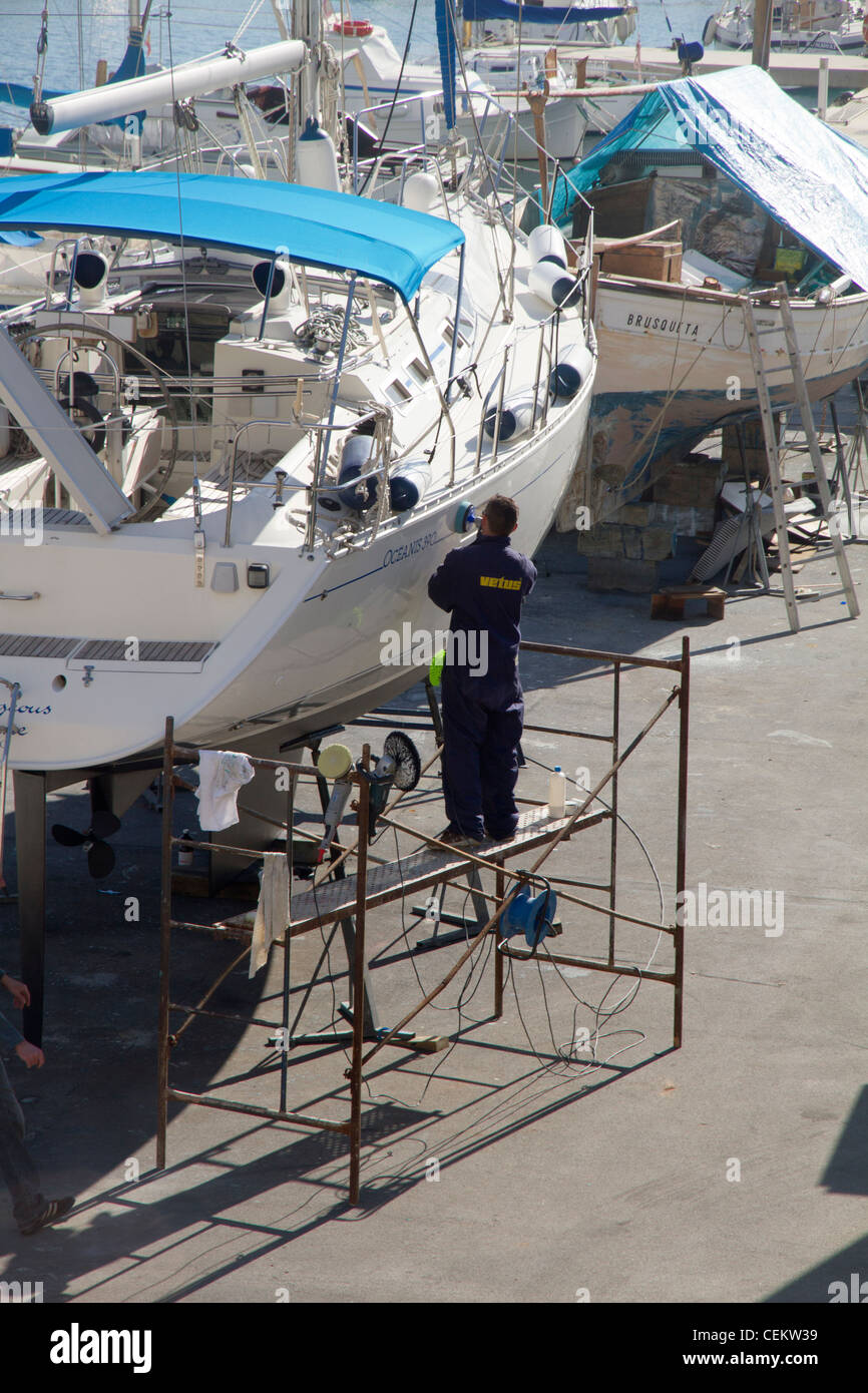 Worker boat yard maintenance area on Cala Nova port nautical yacht club ...