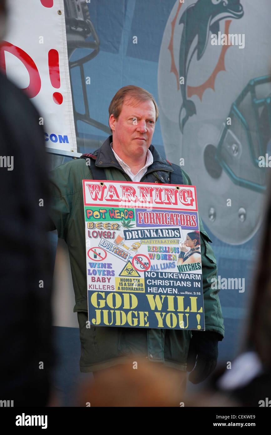 Christian conservative extremist holding sign saying, "God Will Judge ...